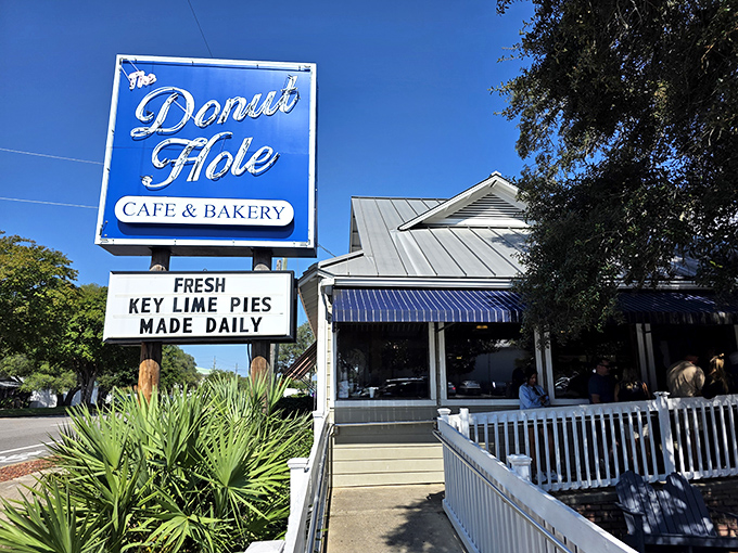 The iconic blue sign promises paradise in pastry form. Like a lighthouse for the hungry, it beckons with the magic words: "Fresh Key Lime Pies Made Daily."