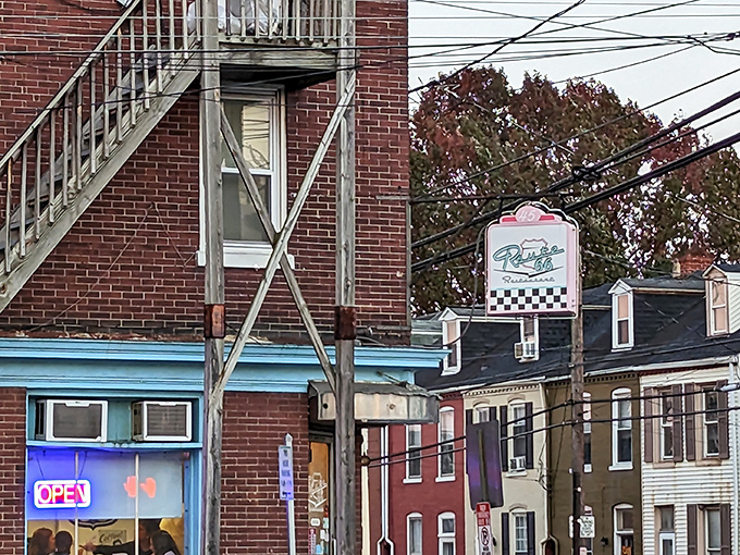 That iconic checkered sign hanging outside promises what every great American diner delivers: unpretentious comfort food that satisfies the soul.
