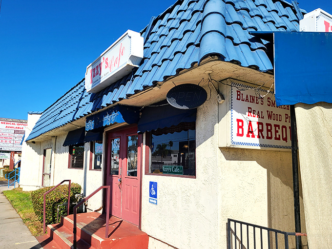 The iconic blue roof of Izzy's Cafe stands out like a beacon for hungry travelers in El Cajon. Comfort food paradise awaits behind that pink door!