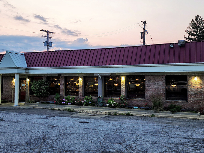 As dusk settles, George's Kitchen's warm glow promises refuge from the day&mdash;a burgundy-roofed sanctuary where hungry souls find solace in homestyle cooking.
