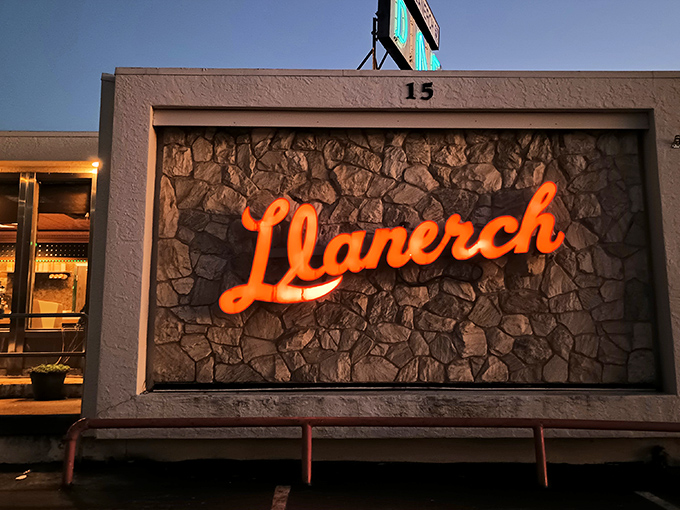 The iconic neon orange Llanerch sign glows against stone, a beacon of comfort food that's been drawing hungry Pennsylvanians for generations.