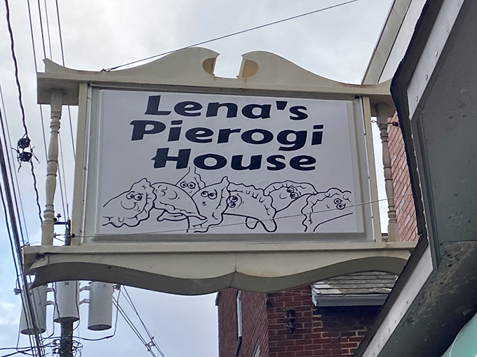 The sign says it all! Lena's Pierogi House welcomes hungry visitors with its whimsical dancing dumplings, promising Eastern European comfort in Hubbard's heart.