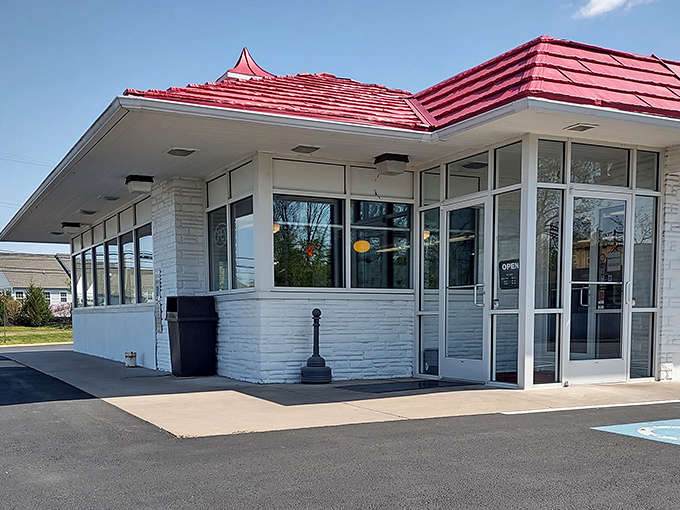 The classic white brick and red roof of Speck's stands like a time capsule of Americana, promising comfort food that transcends trends.