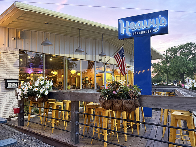 Sunset at Heavy's transforms the patio into a golden-hour haven. Those yellow bar stools aren't just seating&mdash;they're front-row tickets to flavor town.