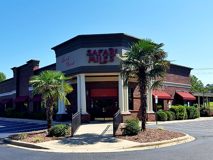 Palm trees in North Carolina? Safari Miles' brick exterior with tropical touches creates an unexpected oasis that promises culinary adventures within.