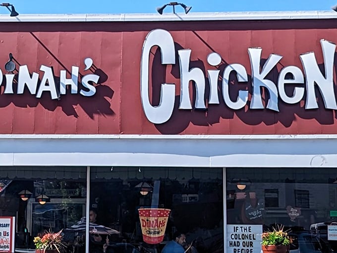 The iconic Dinah's Chicken sign beckons hungry travelers with its vintage charm—a beacon of crispy, golden perfection in Glendale.
