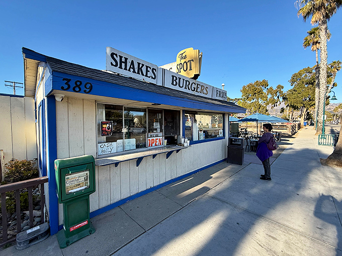 The iconic blue-and-white facade of The Spot stands as a beacon of burger bliss on Carpinteria's Linden Avenue, promising simple perfection since long before "artisanal" became a buzzword.