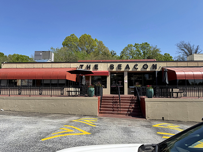 The iconic red awnings of The Beacon beckon hungry travelers like a culinary lighthouse on Spartanburg's dining landscape.
