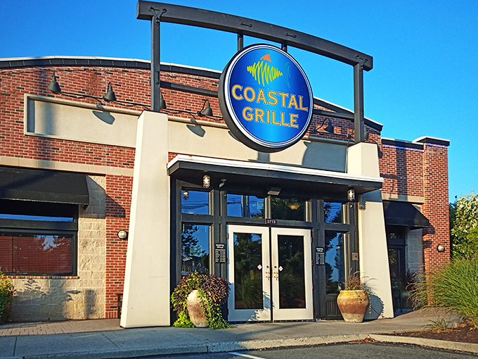 The bright blue sign beckons like a lighthouse for hungry souls. Coastal Grille's welcoming entrance promises seafood salvation in suburban Wyomissing. 