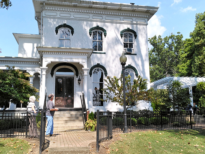 The grand white Italianate façade of Hart Mansion stands proudly against a blue Ohio sky, promising culinary adventures within its historic walls.