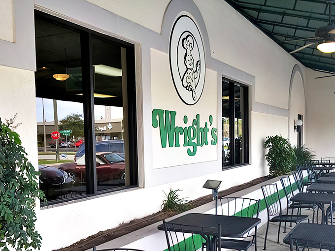 The iconic green-and-white striped awning of Wright's Gourmet House stands as a beacon to sandwich pilgrims. Tampa's culinary landmark has been drawing crowds for decades.