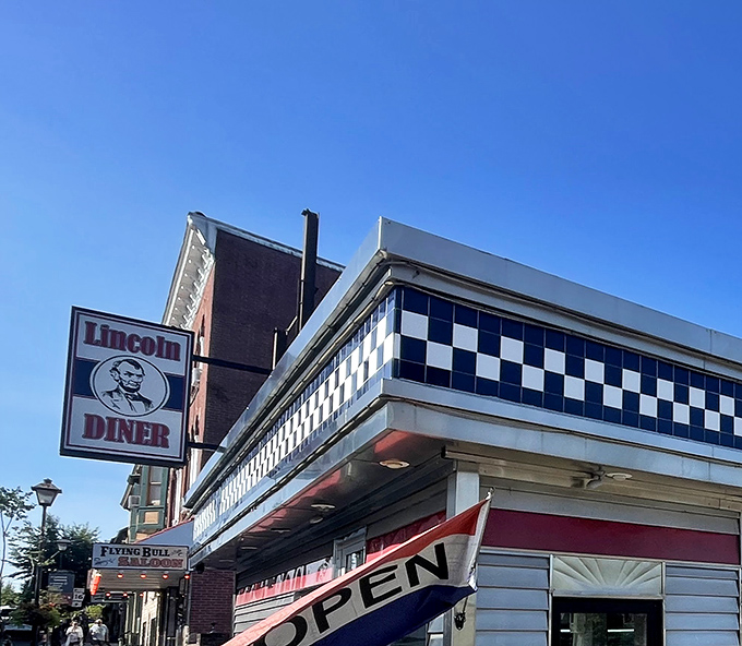 The iconic checkerboard trim and neon signage of Lincoln Diner glows like a beacon for hungry travelers in historic Gettysburg.