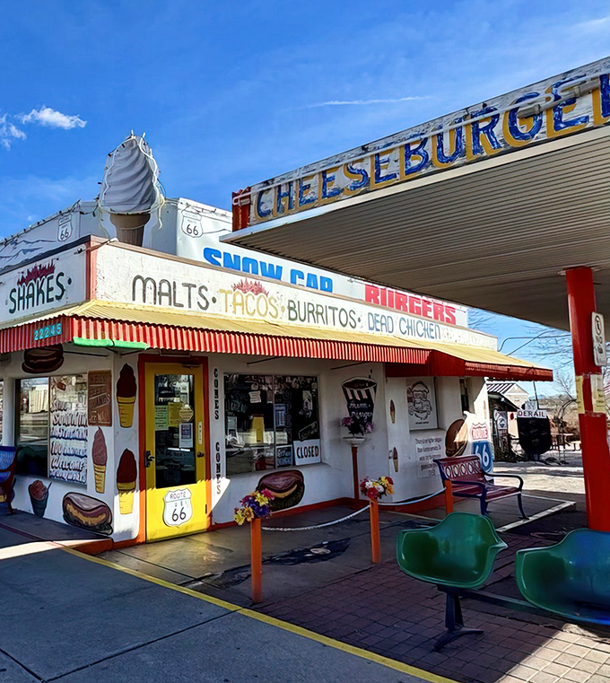 The Snow Cap's exterior is a masterpiece of roadside whimsy, complete with a giant ice cream cone that's been tempting travelers since the heyday of Route 66.