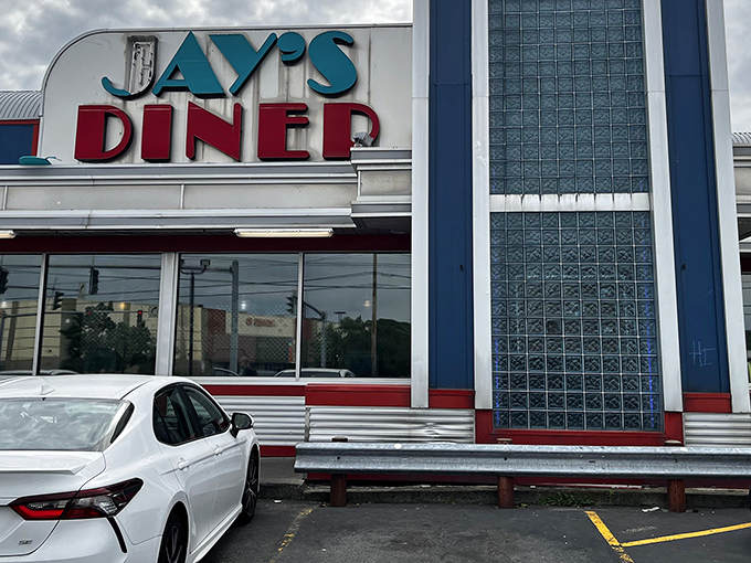 The iconic blue and red neon sign of Jay's Diner stands as a beacon of comfort food in Rochester, promising retro charm and 24-hour sustenance.