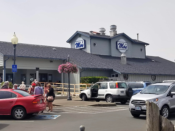 The iconic blue-gray exterior of Mo's stands like a lighthouse for hungry travelers, beckoning with promises of seafood treasures within.