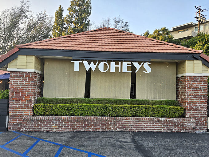 The iconic Twohey's exterior welcomes hungry patrons with its classic brick fa&ccedil;ade and mid-century charm &ndash; a culinary time machine waiting to transport you.