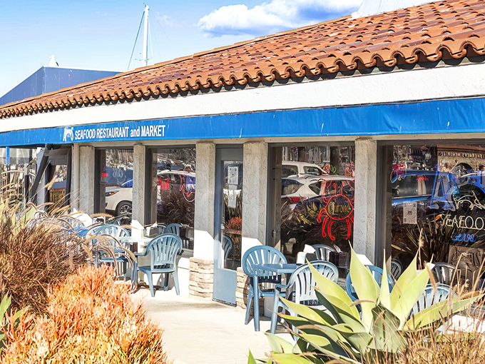 Beneath Spanish tiles and blue awnings, this unassuming harbor gem houses seafood treasures worth traveling miles to experience.