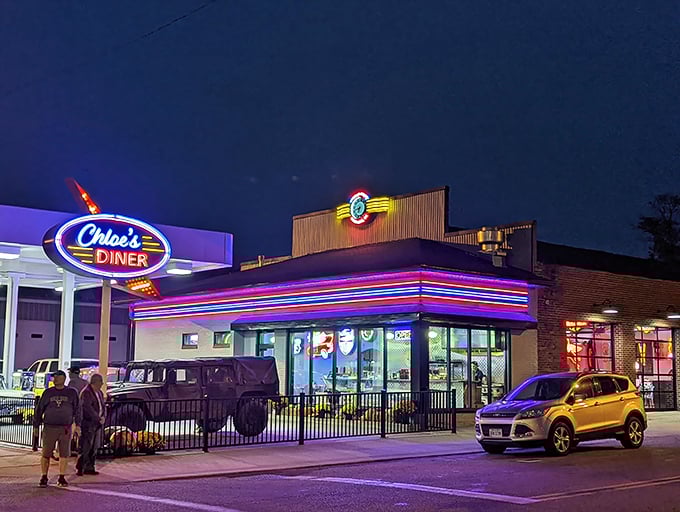 Chloe's Diner beckons with its classic Americana exterior, where red umbrellas dot the patio like cherry-topped sundaes waiting to be savored.