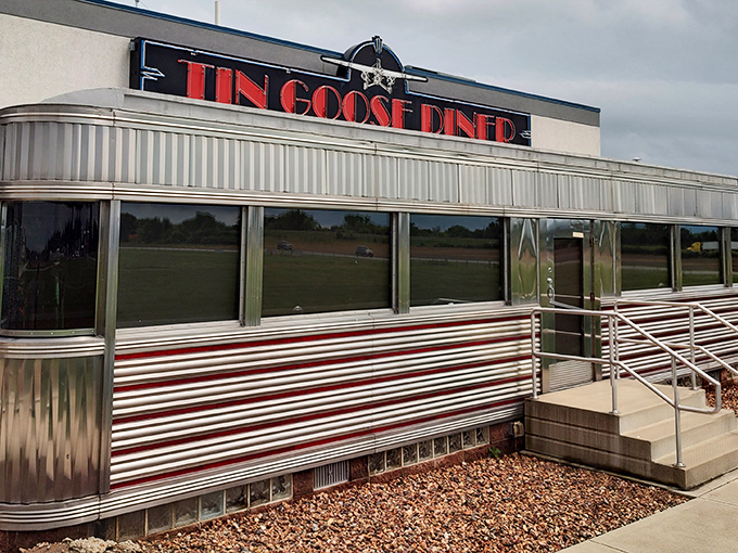 The gleaming stainless steel exterior of Tin Goose Diner shines like a beacon of nostalgia against the Ohio sky, promising comfort food with a side of aviation history.