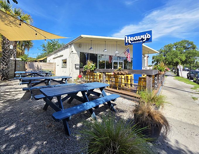 Heavy's iconic blue sign and casual outdoor seating area create the perfect backdrop for burger bliss. No pretension, just picnic tables and palm trees.