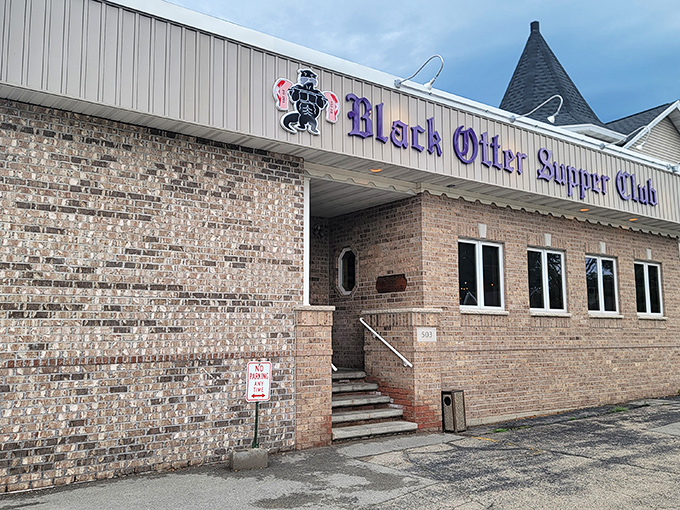 The brick facade of Black Otter Supper Club stands as a beacon of comfort in Hortonville, promising Wisconsin traditions and prime rib perfection behind those doors.