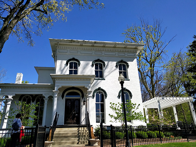 The grand white Italianate fa&ccedil;ade of Hart Mansion stands proudly against a blue Ohio sky, promising culinary adventures within its historic walls.