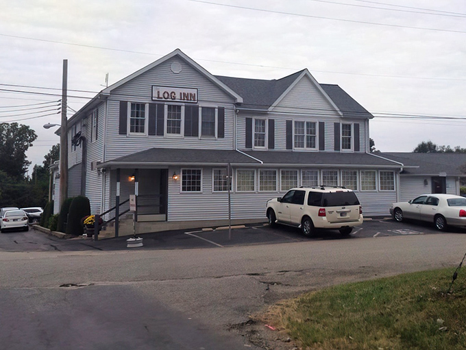 Another angle of The Log Inn's charming exterior reveals its welcoming entrance. Like a time capsule of Hoosier hospitality, it beckons hungry travelers from miles around.