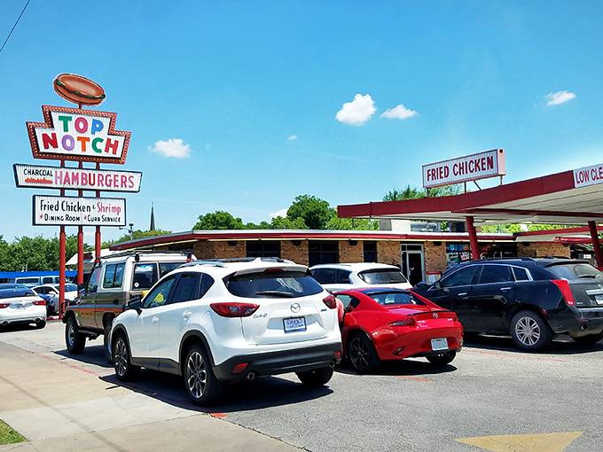 That iconic Top Notch sign has been beckoning hungry Austinites for decades, promising charcoal-grilled perfection under the Texas sky.