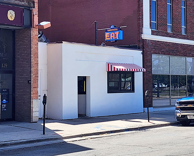The unassuming white facade of Al's Hamburger in Green Bay might not scream "culinary landmark," but that red-striped awning is practically a bat signal for burger lovers.