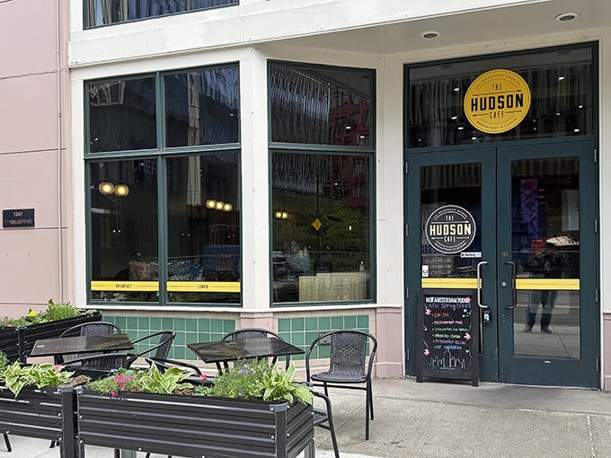 The sleek exterior of The Hudson Cafe stands as a modern beacon for breakfast enthusiasts on Woodward Avenue, complete with inviting patio seating.