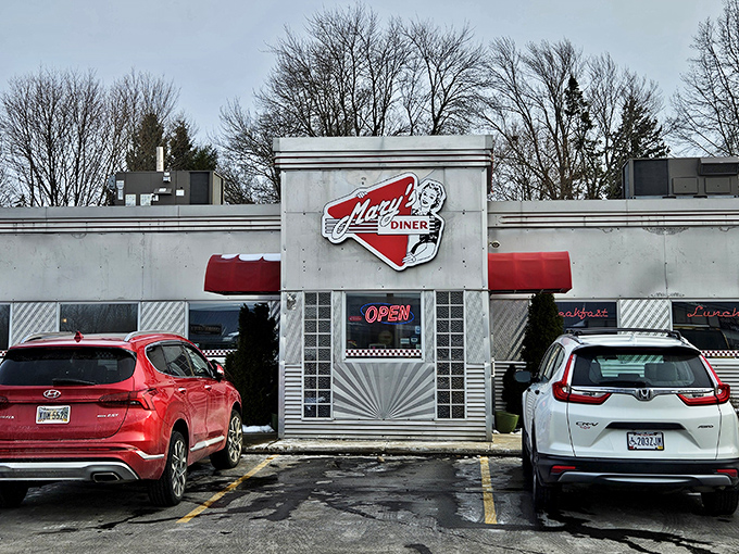 Step back in time with this classic diner entrance, where the neon "OPEN" sign has welcomed hungry travelers and locals alike through decades of American dining history.