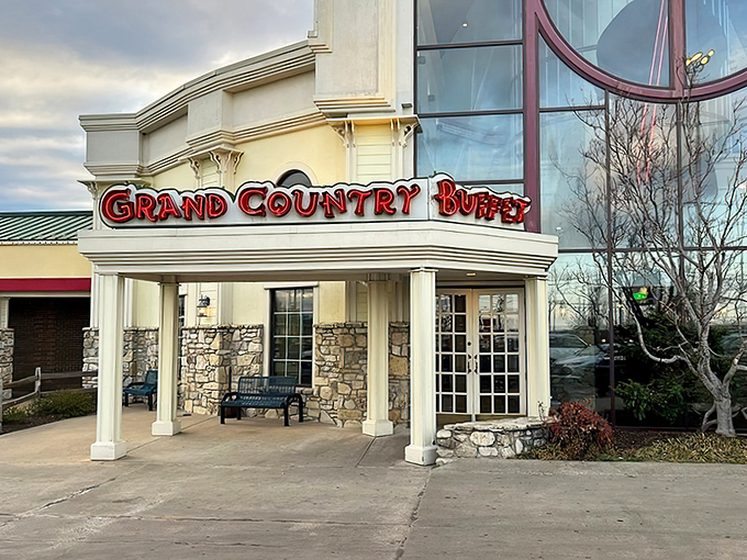 The welcoming facade of Grand Country Buffet beckons hungry travelers with its stone columns and bold signage&mdash;like a beacon of comfort food in Branson's entertainment landscape.