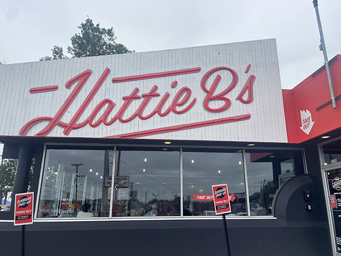 The black-and-white facade with that bold red &lsquo;Hattie B&rsquo;s&rsquo; sign isn&rsquo;t just architecture&mdash;it&rsquo;s Nashville&rsquo;s equivalent of a lighthouse guiding hungry souls to spicy salvation.