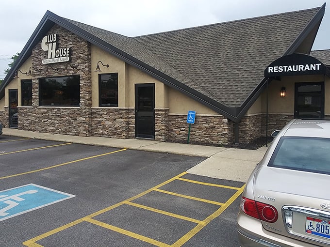 The stone-and-stucco exterior of Clubhouse Restaurant + Bar stands like a culinary fortress, promising comfort food treasures within its peaked-roof kingdom.
