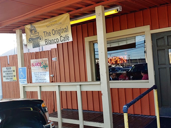The humble coral exterior of Blanco Cafe stands like a culinary lighthouse, beckoning hungry travelers with its promise of enchilada excellence.