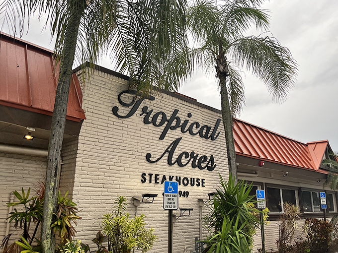 The iconic brick facade with "Tropical Acres" script has welcomed hungry Floridians since 1949. Some buildings age; this one seasons.