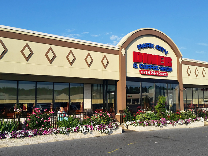 The welcoming facade of Park City Diner stands like a beacon for hungry travelers, its colorful flower beds promising the same attention to detail you'll find inside.