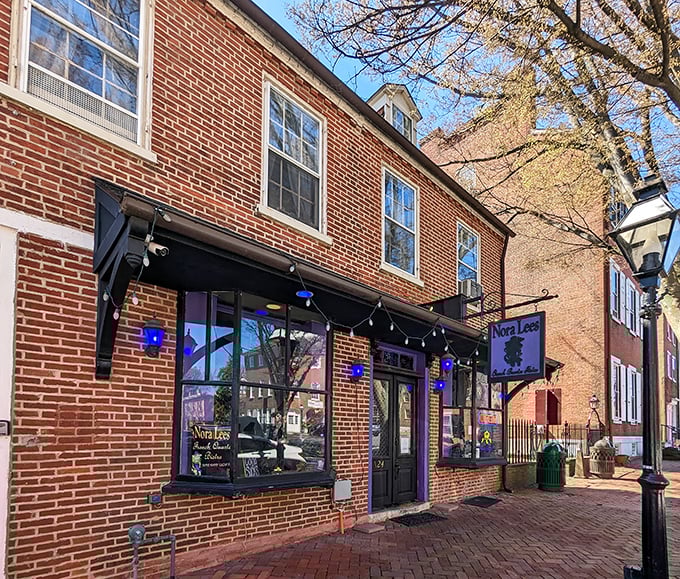 The unassuming brick exterior of Nora Lees hides culinary treasures within, like a delicious secret waiting to be discovered on New Castle's historic streets.