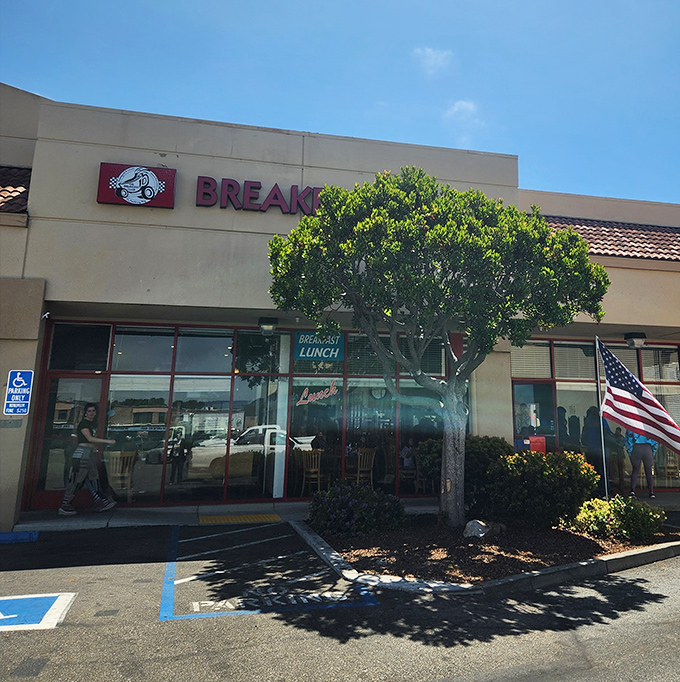 Morning sunshine illuminates the entrance, where the American flag waves as if to say, "Patriotism begins with proper pancakes."