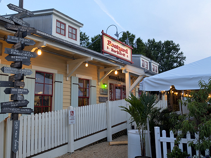 The cheerful yellow exterior of Boatyard Bar & Grill welcomes seafood lovers with its charming nautical signpost pointing to faraway ports. Maritime magic awaits!