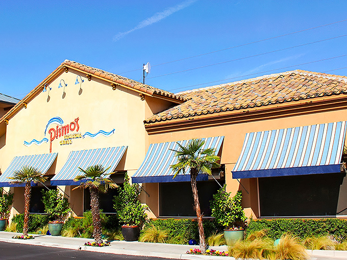 The Mediterranean-inspired exterior with its terracotta roof and blue-striped awnings makes you feel like you've teleported to a coastal village rather than central Fresno.