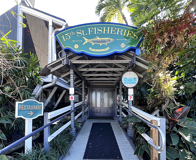 The entrance to 15th Street Fisheries feels like the gateway to a maritime adventure, complete with tropical foliage standing guard like friendly sea monsters.