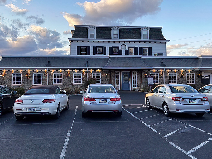 Twilight transforms this historic stone building into a beacon for hungry travelers, its mansard roof silhouetted against Pennsylvania's evening sky.