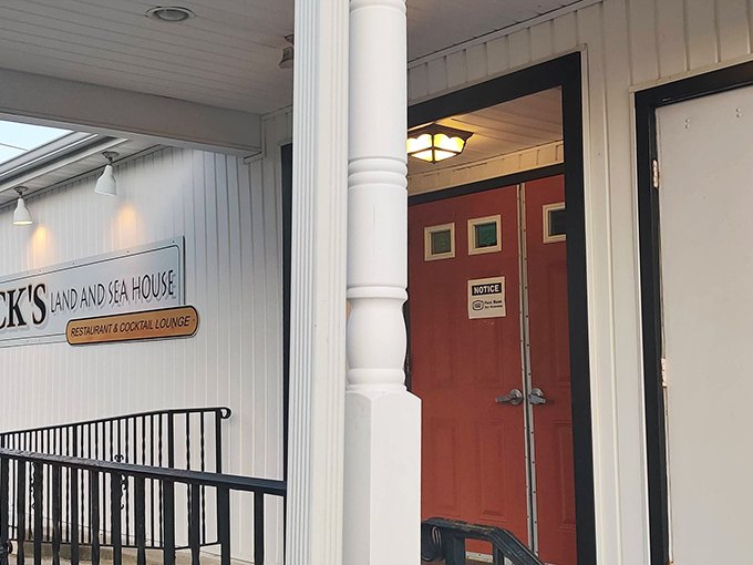 The unassuming entrance to Beck's Land & Sea House proves that extraordinary culinary experiences often hide behind ordinary doors. That red door? It's practically a portal to seafood paradise.