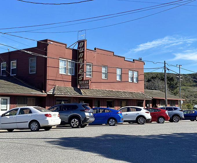 The iconic brick-red exterior of Duarte's Tavern stands proudly on Pescadero's main drag, its vintage neon sign beckoning hungry travelers like a coastal lighthouse.