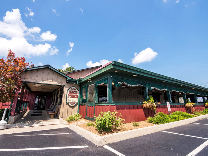 The unassuming exterior of Back Porch Saloon beckons like an old friend, promising comfort food treasures within its rustic wooden walls.
