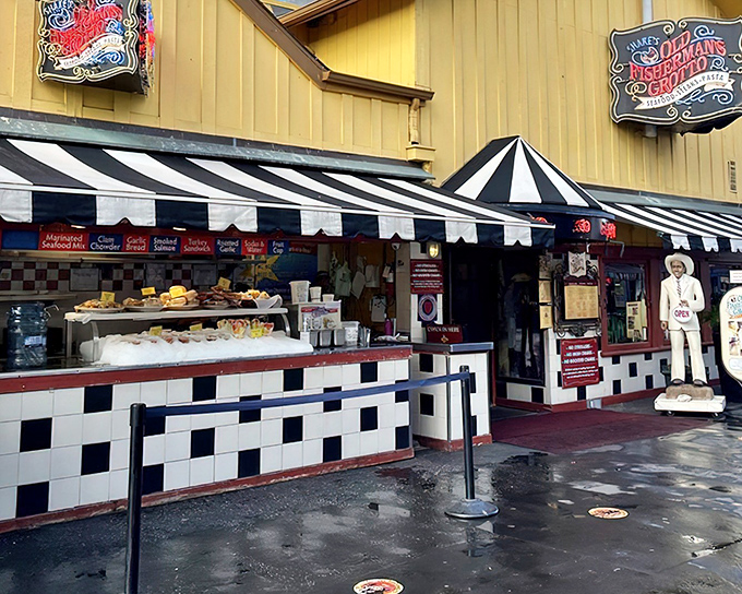 The cheerful yellow exterior of Old Fisherman's Grotto stands like a beacon on Monterey's wharf, promising seafood treasures within those striped-awning doors.