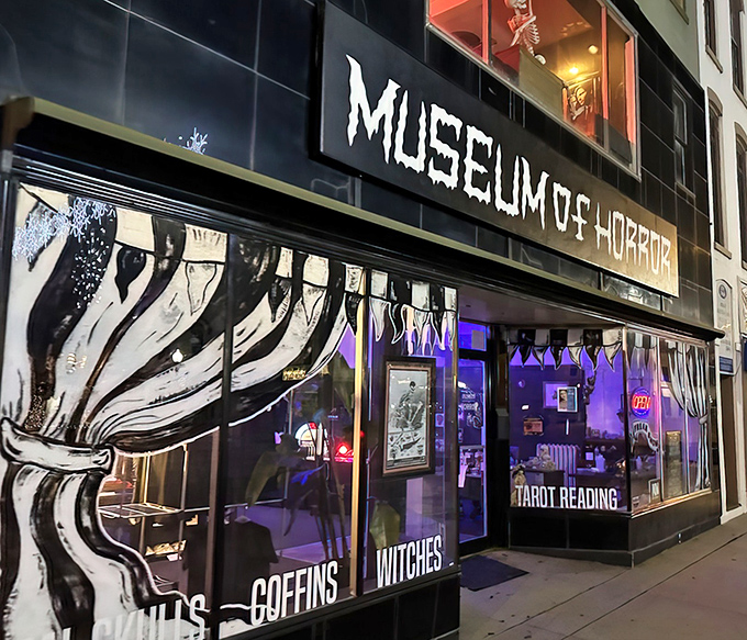 The striking black facade of Monroe's Museum of Horror beckons brave souls with its dramatic signage and purple-lit windows.