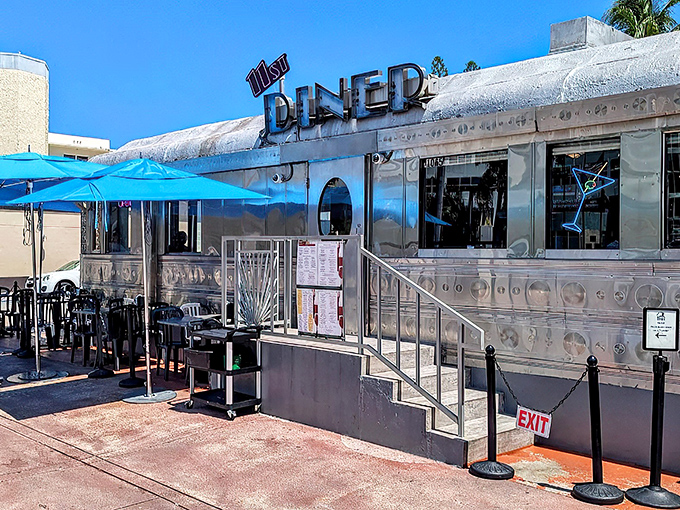 The gleaming silver exterior of 11th Street Diner shines like a beacon of nostalgia under Miami's blue skies, promising delicious time travel with every meal.