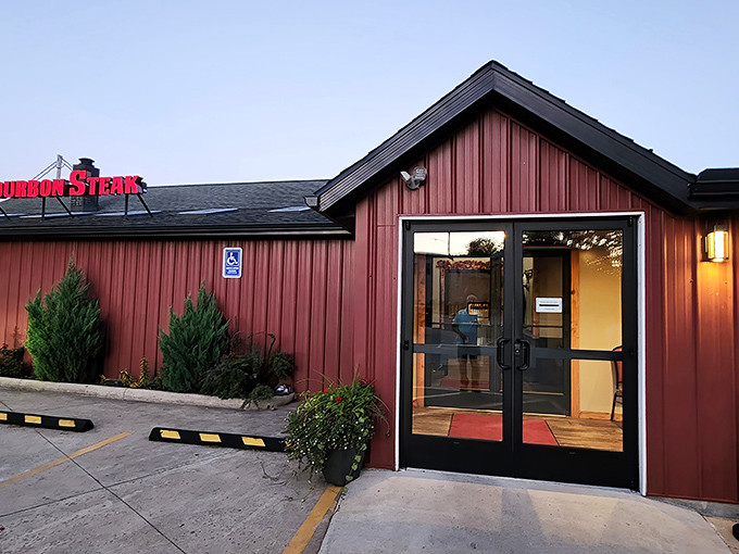 The rustic red exterior of Joe Tony's Bourbon Steak beckons like a culinary lighthouse in New Philadelphia, promising comfort and indulgence behind those glass doors.